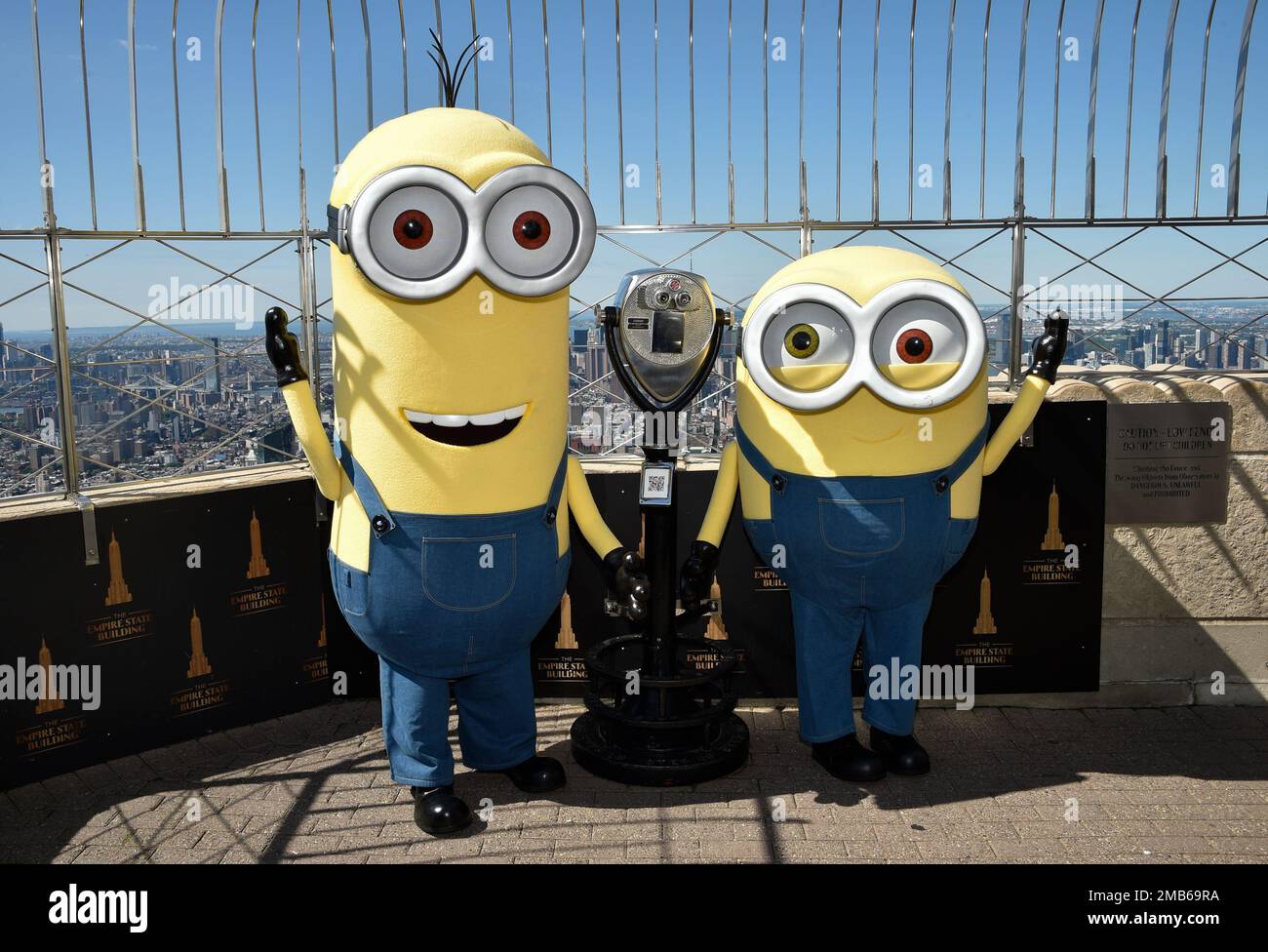 Two Minion characters pose on the 86th floor observatory deck at the ...