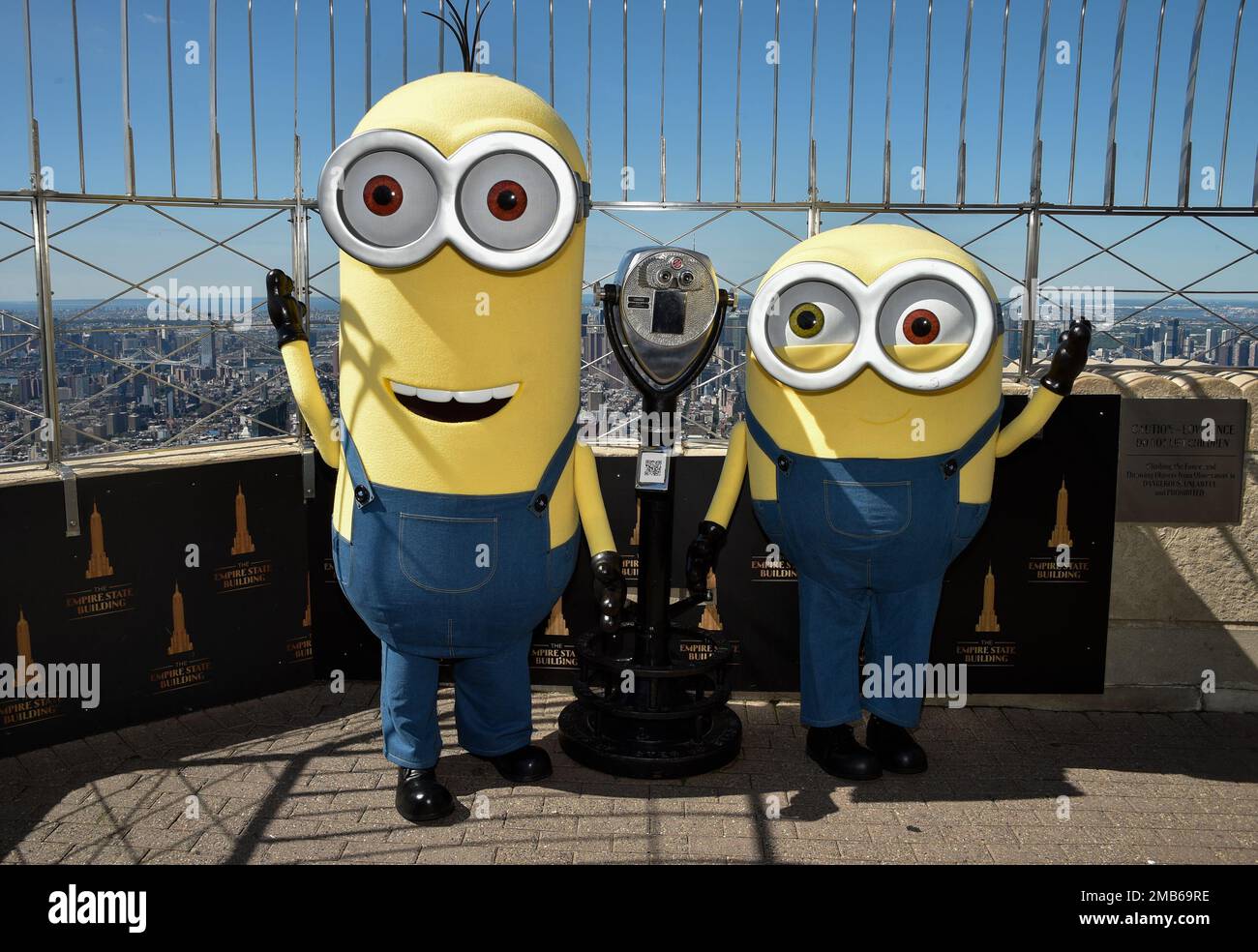 Two Minion characters pose on the 86th floor observatory deck at the ...