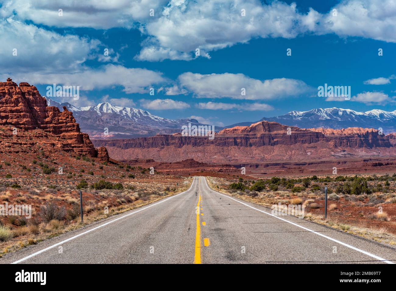 Trachyte Point Plateau cliffs, snowcapped Henry Mountains in dist, view ...