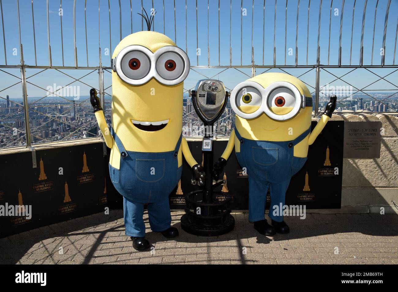 Two Minion characters pose on the 86th floor observatory deck at the ...