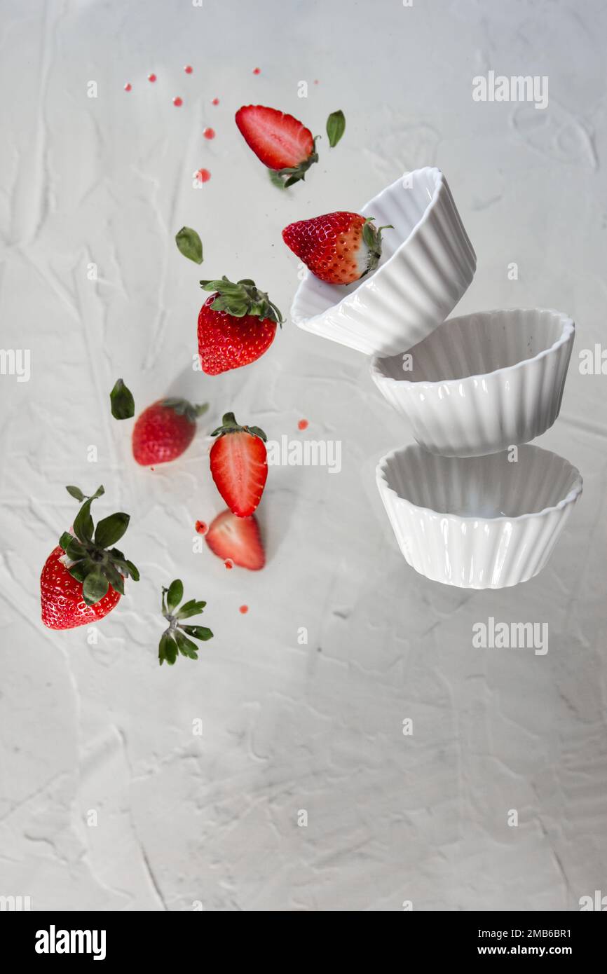 Red strawberries levitating on a white background. Levitation effect ...