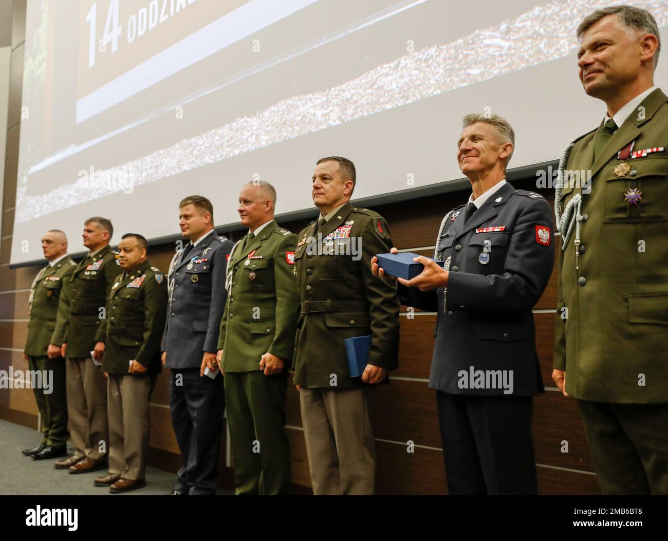 Polish and U.S. Soldiers stand at attention after receiving ...