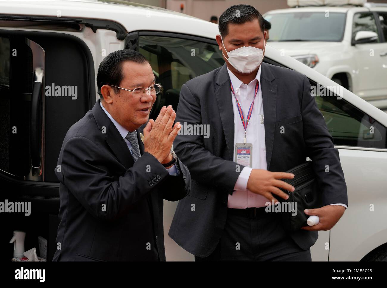 Cambodian Prime Minister Hun Sen, left, greets party members upon his ...