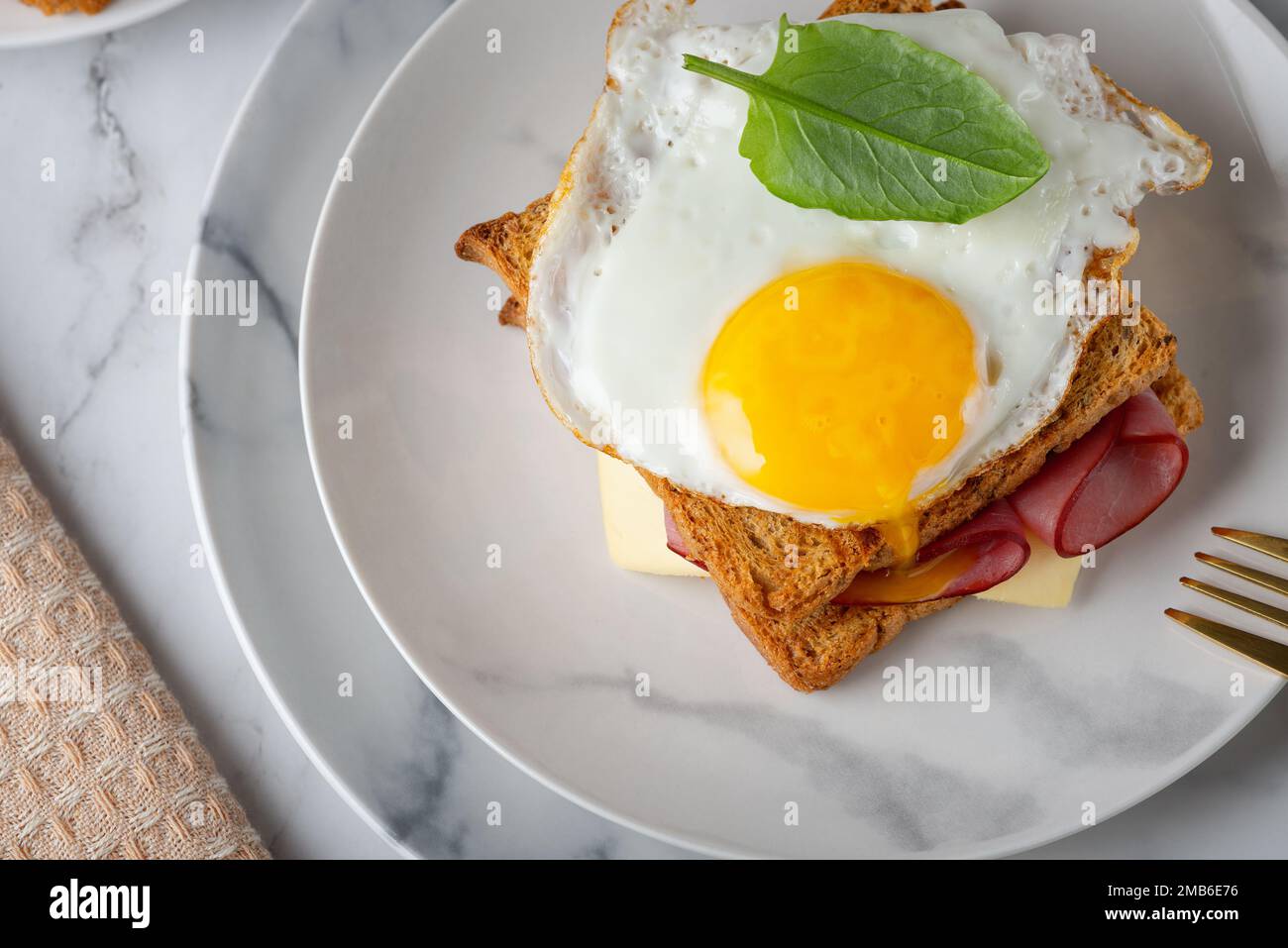 Slice of toasted bread with ham and fried eggs Stock Photo - Alamy