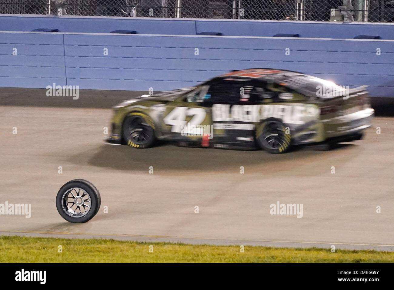 Ty Dillon (42) drives around a tire rolling down the track during a ...