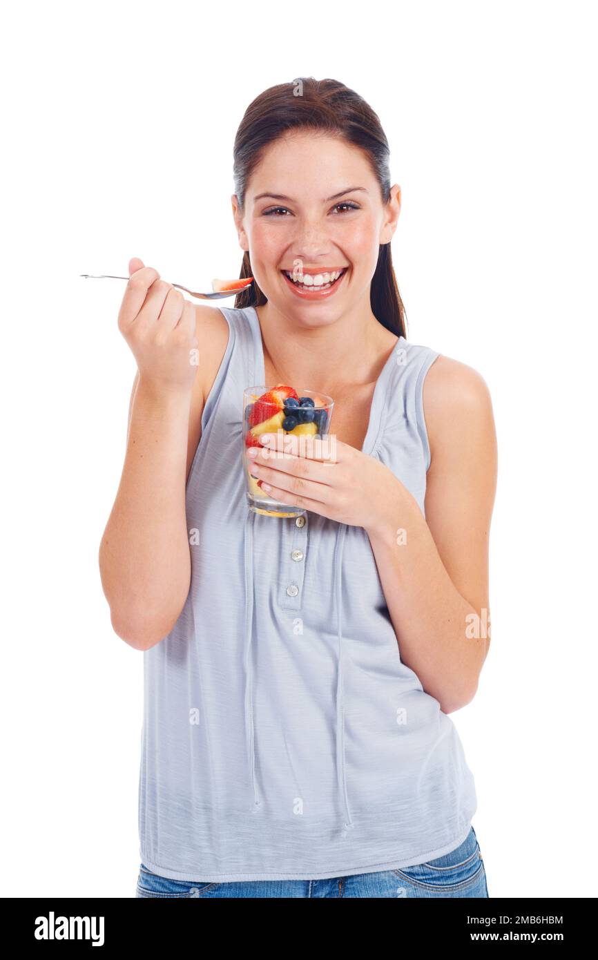 Taking the healthy choice. Cute young woman eating a healthy meal while ...