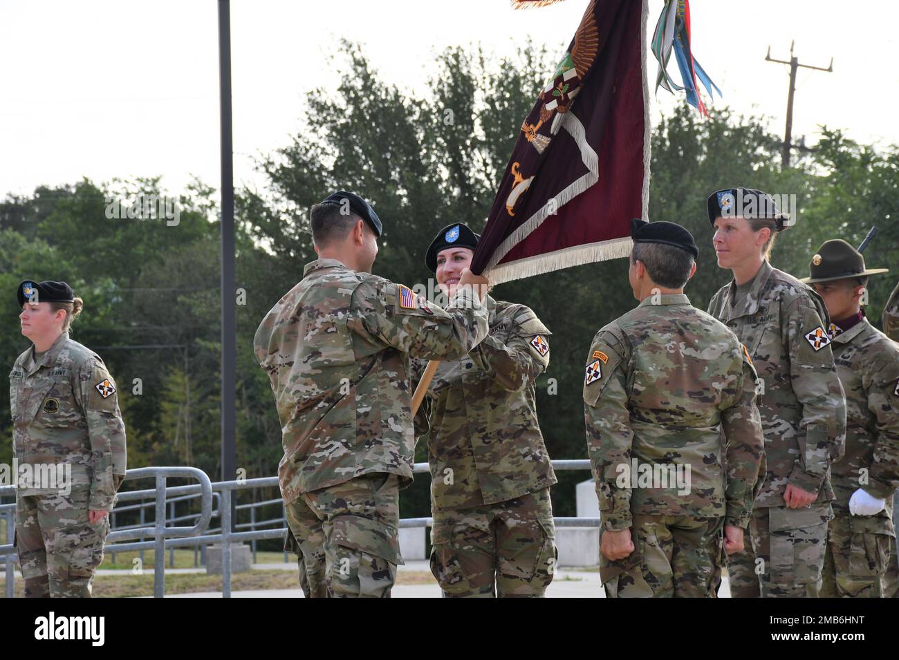 Col. Marc Welde, commander of the 32d Medical Brigade, left, passes the unit colors to Lt. Col ...