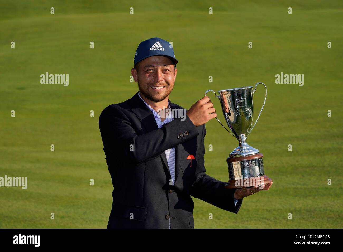 Xander Schauffele poses for pictures after winning the Travelers ...