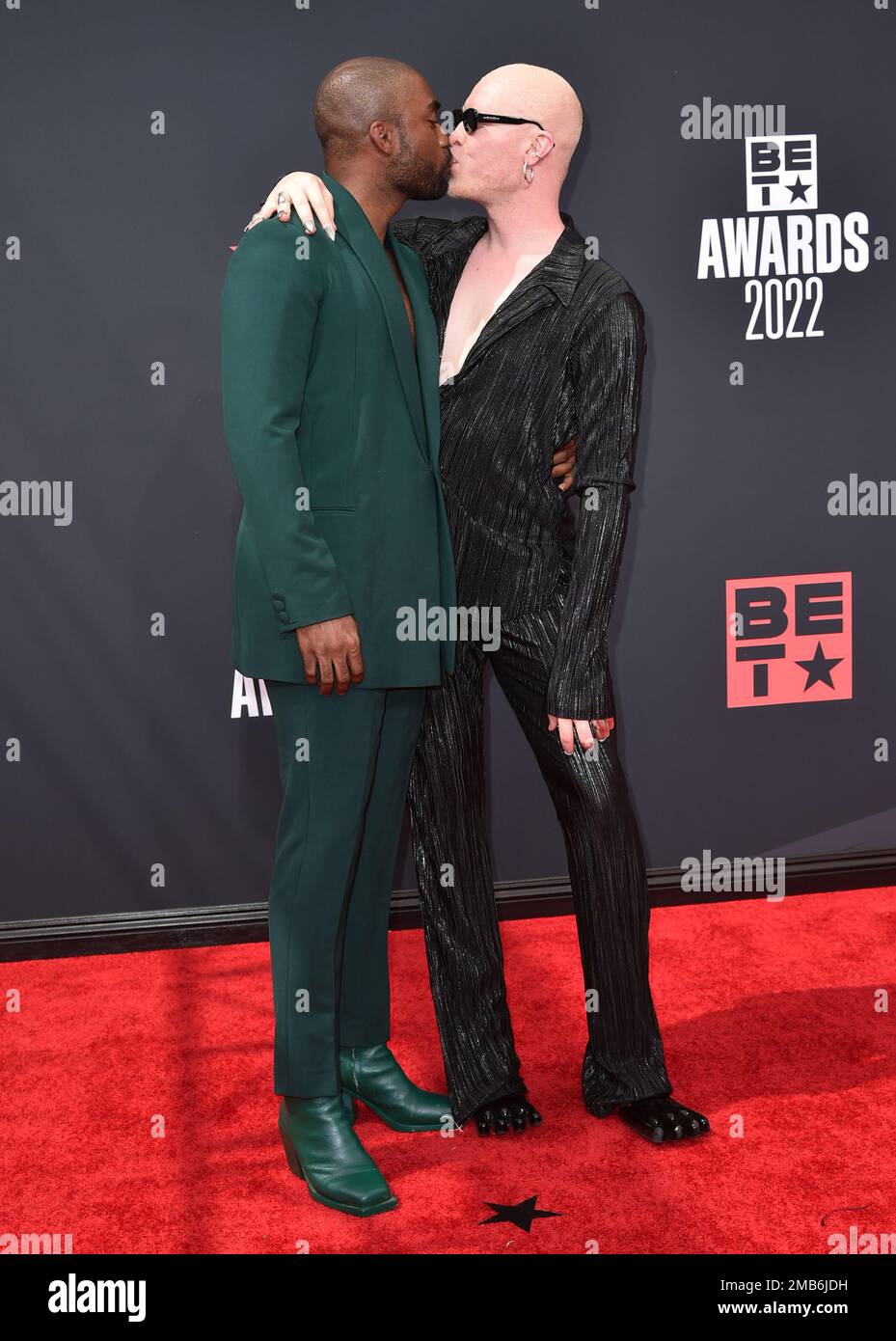 David Alan Madrick, left, and Shaun Ross kiss as they arrive at the BET ...