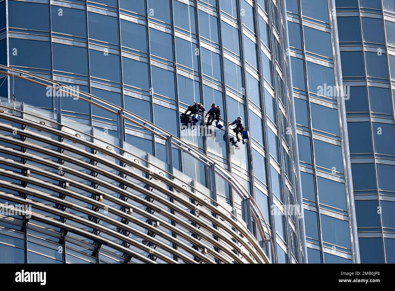 industrial climbers wash the windows of a skyscraper at altitude Stock ...