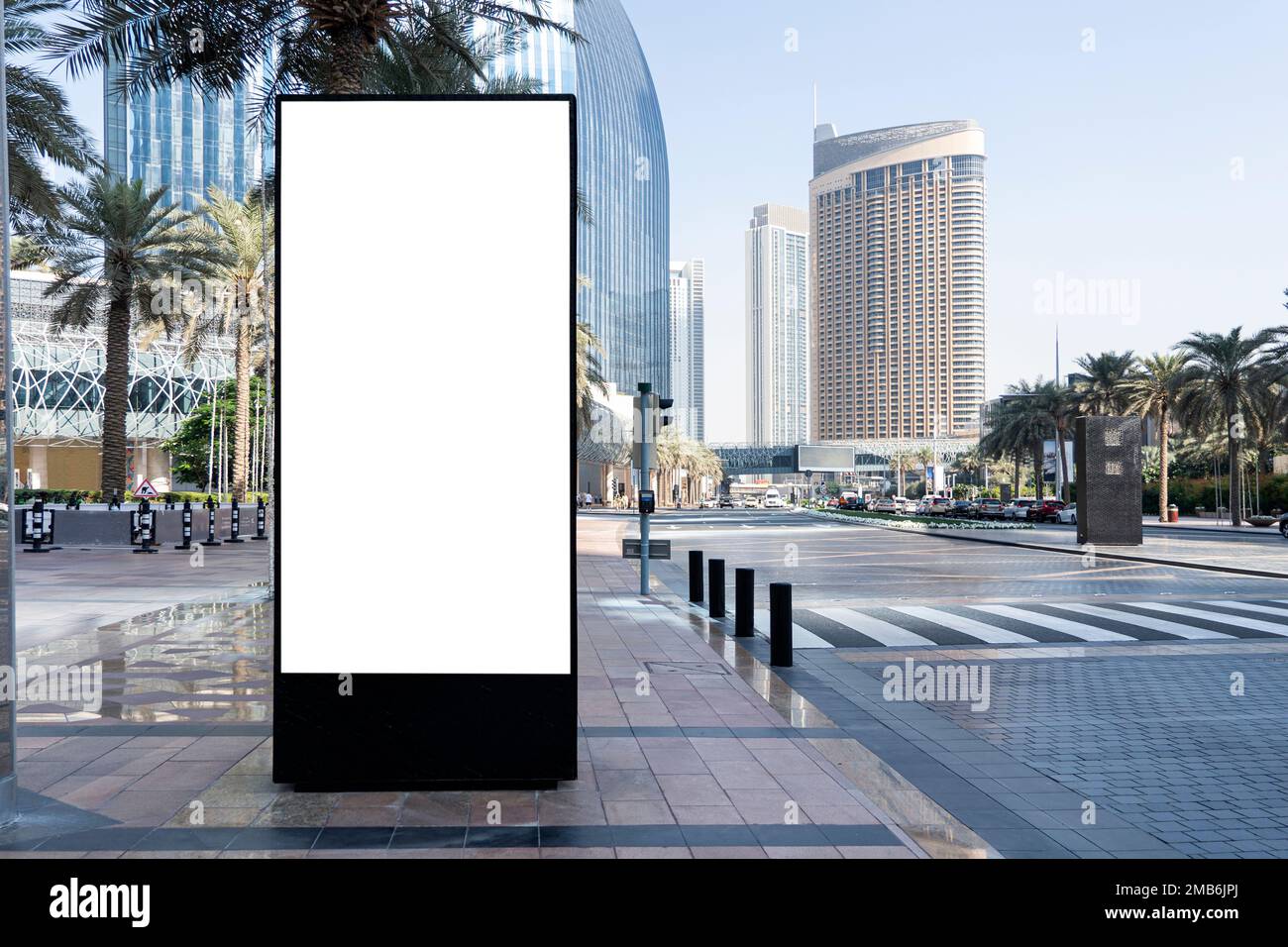 An electronic scoreboard with an empty white screen on a city street ...