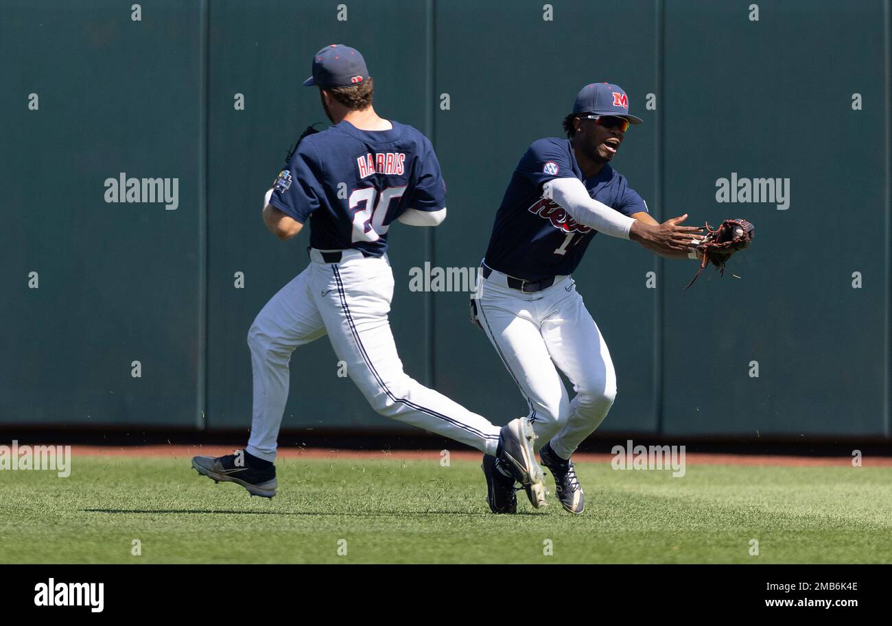 Mississippi's TJ McCants, right, catches a fly ball to center field by ...