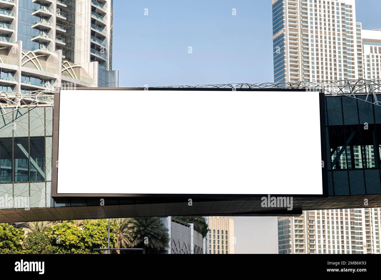 An electronic scoreboard with an empty white screen on a city street ...