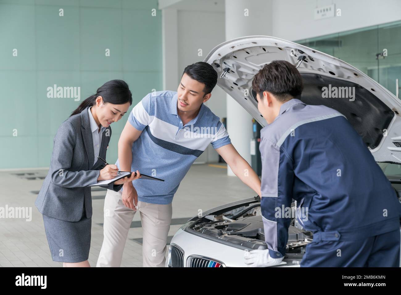 Repair shop mechanics of personnel with the customer Stock Photo - Alamy