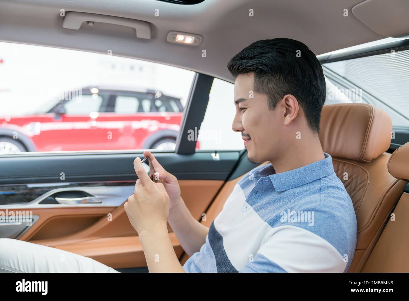 Business man in the car to use mobile phones Stock Photo - Alamy