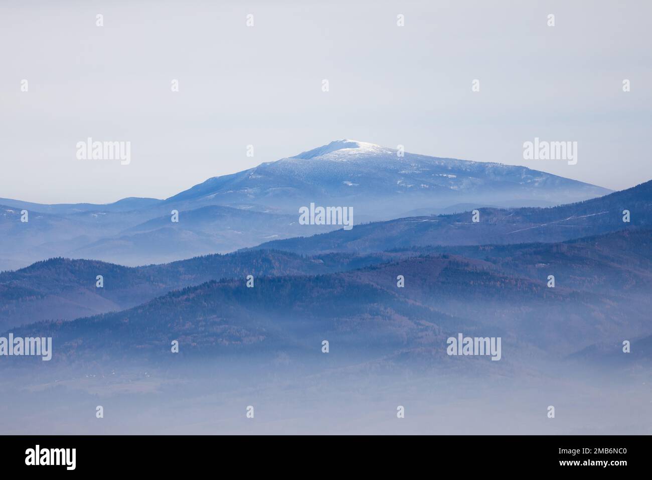 Dramatic winter landscape with hills and valleys covered with fog Stock ...