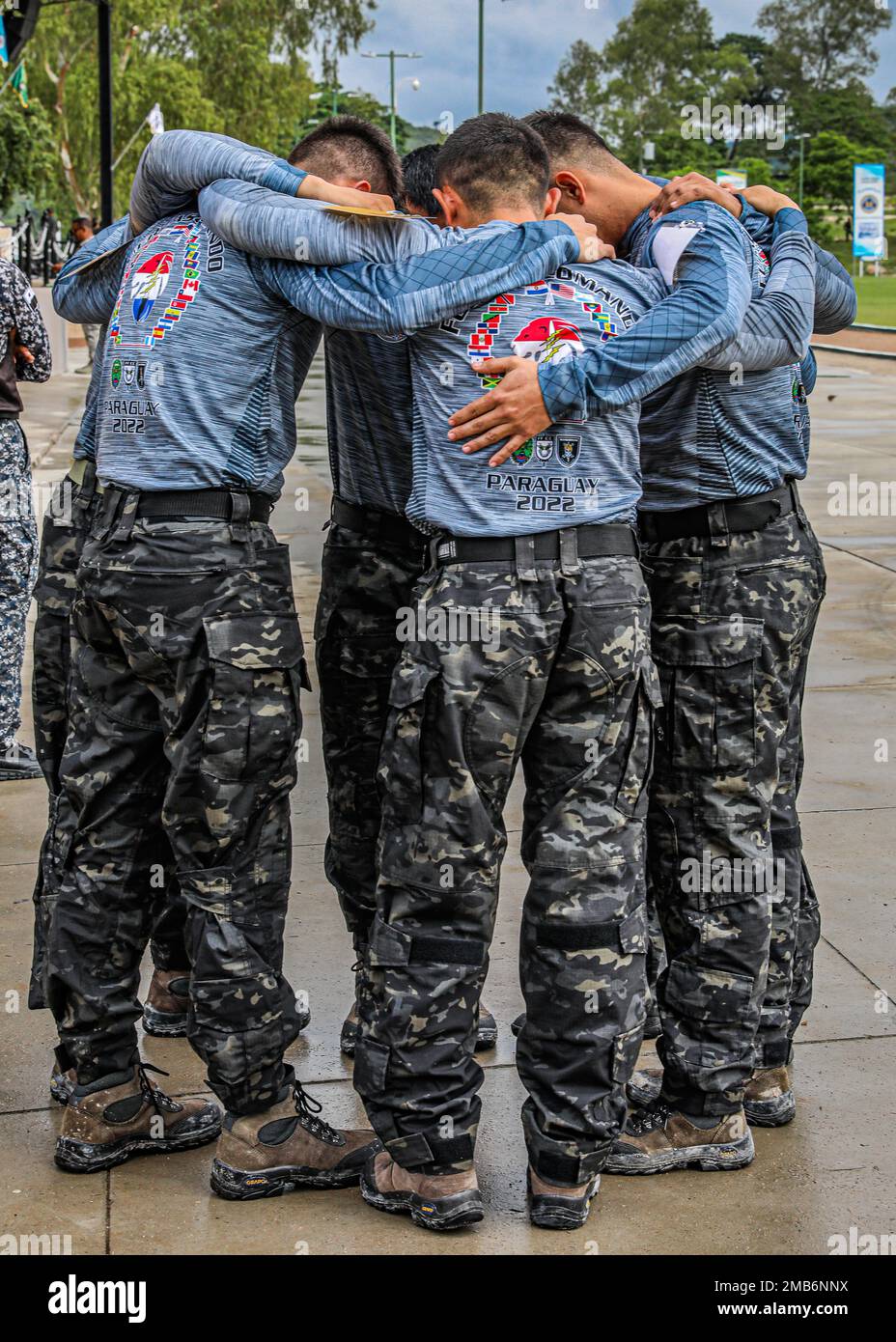 Competitors from the Paraguayan military share a moment before ...