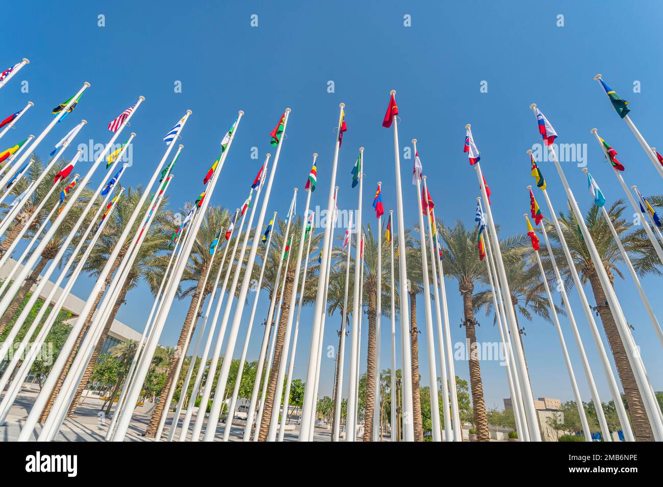 Different flags of many countries on sky background. Bottom view. the ...