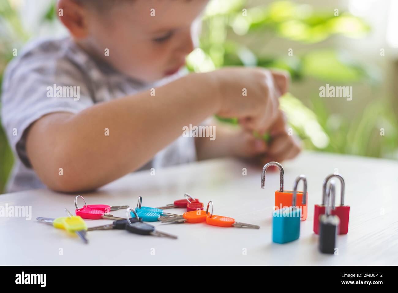 The child works with Montessori material with colored locks. Picks up ...