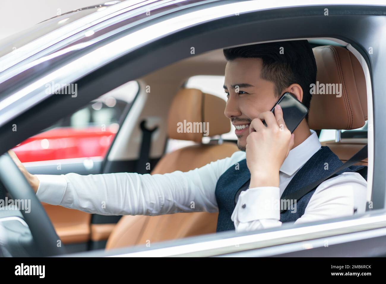 Business man in the car to use mobile phones Stock Photo - Alamy