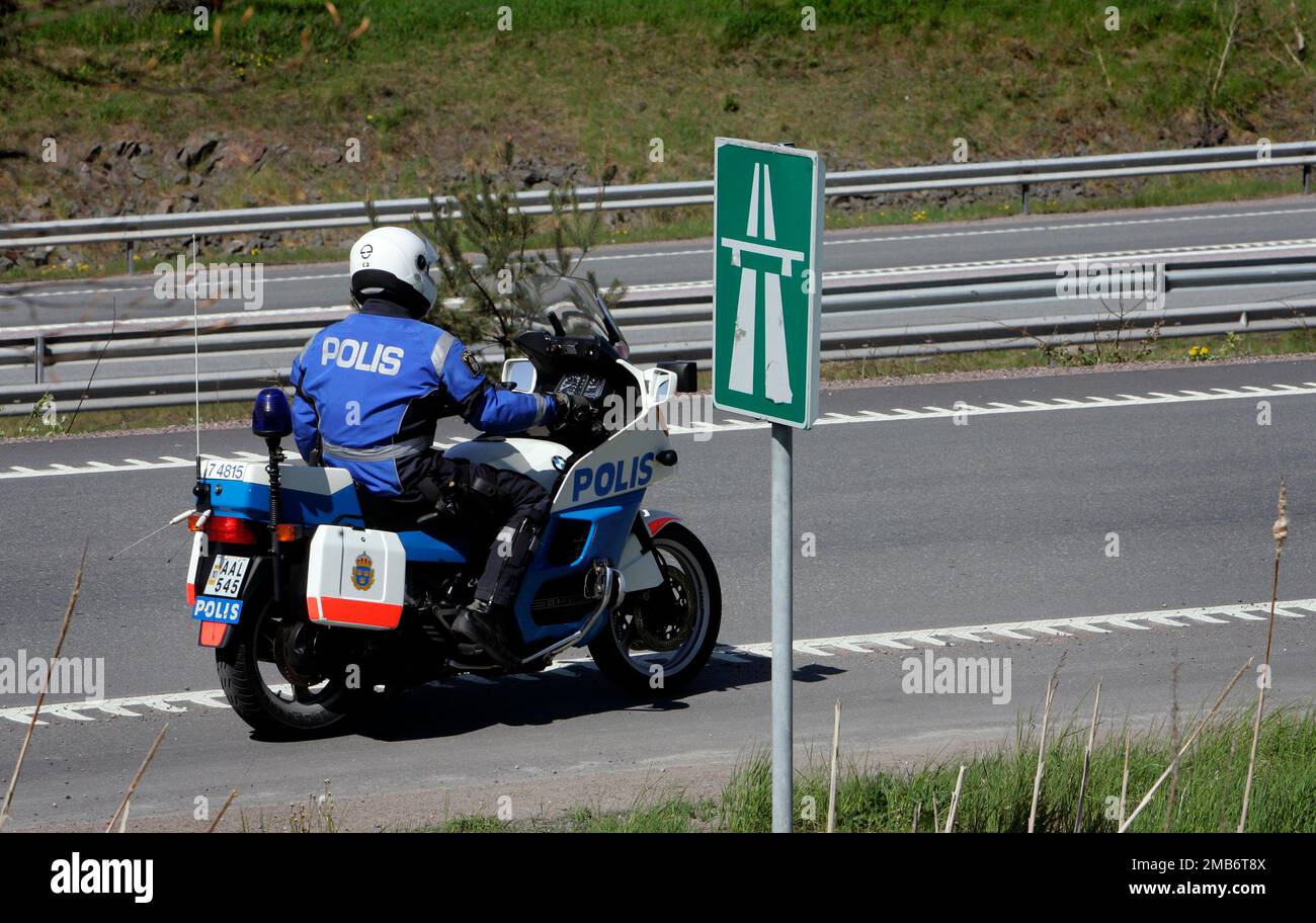 A motorcycle police officer monitoring traffic on the E4 highway just ...