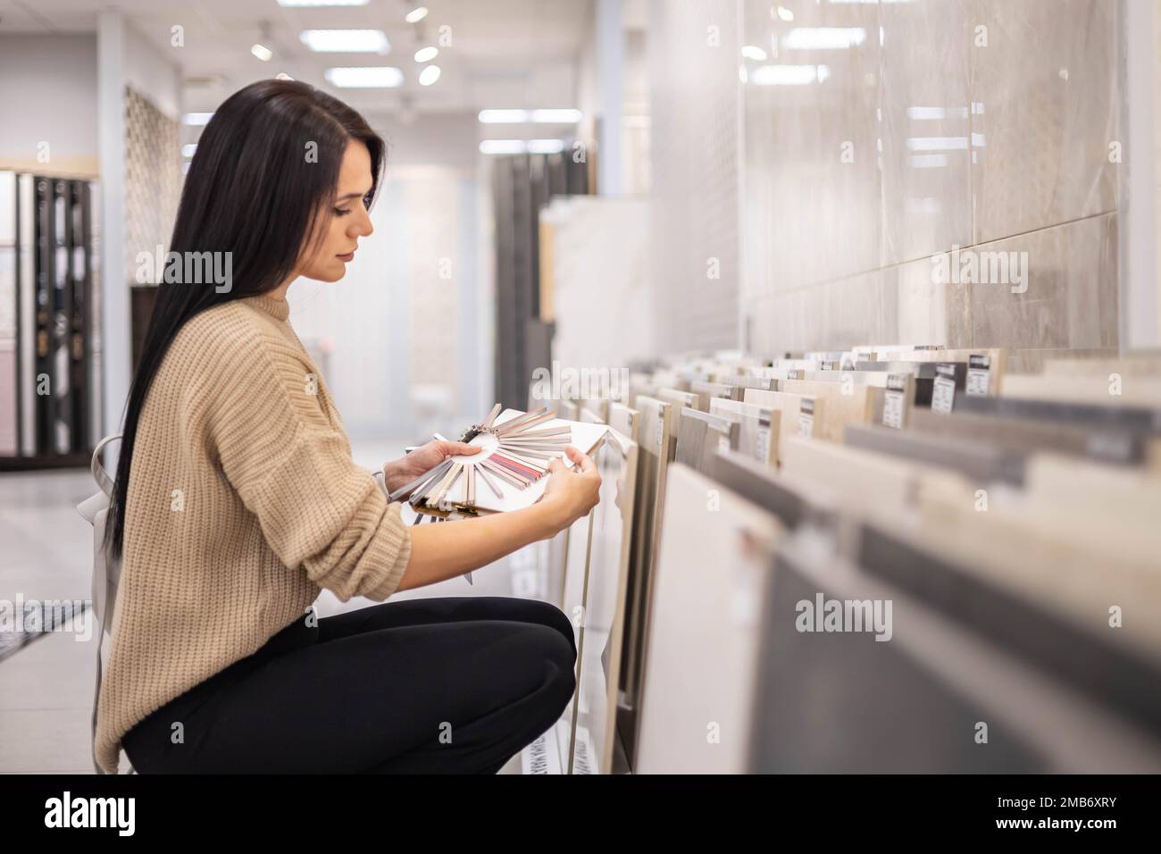 Woman architect designer select epoxy grout ceramic tiles compare ...