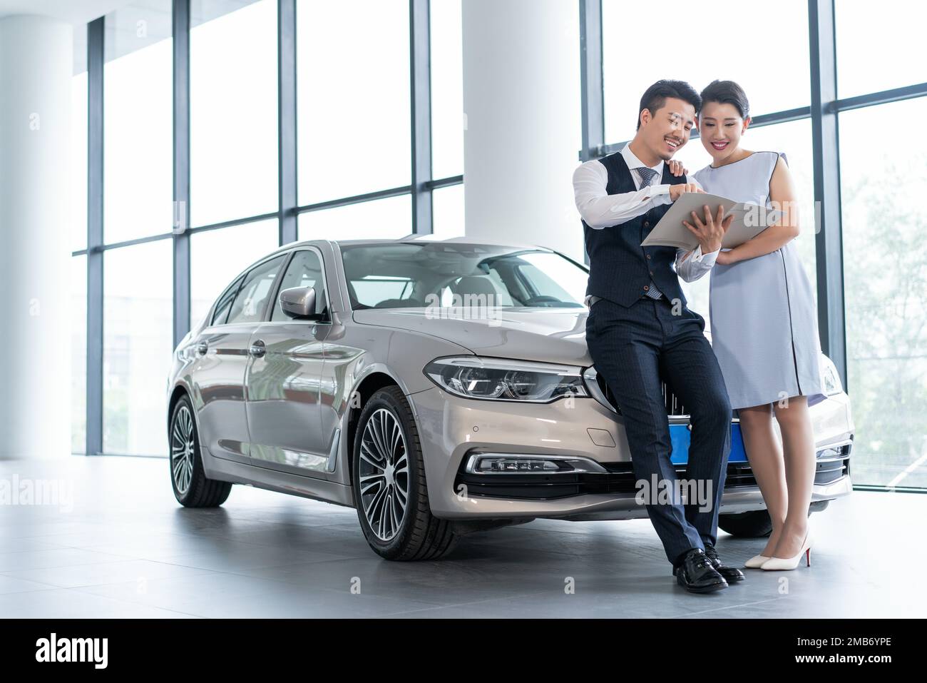 A young couple of choose and buy cars Stock Photo - Alamy