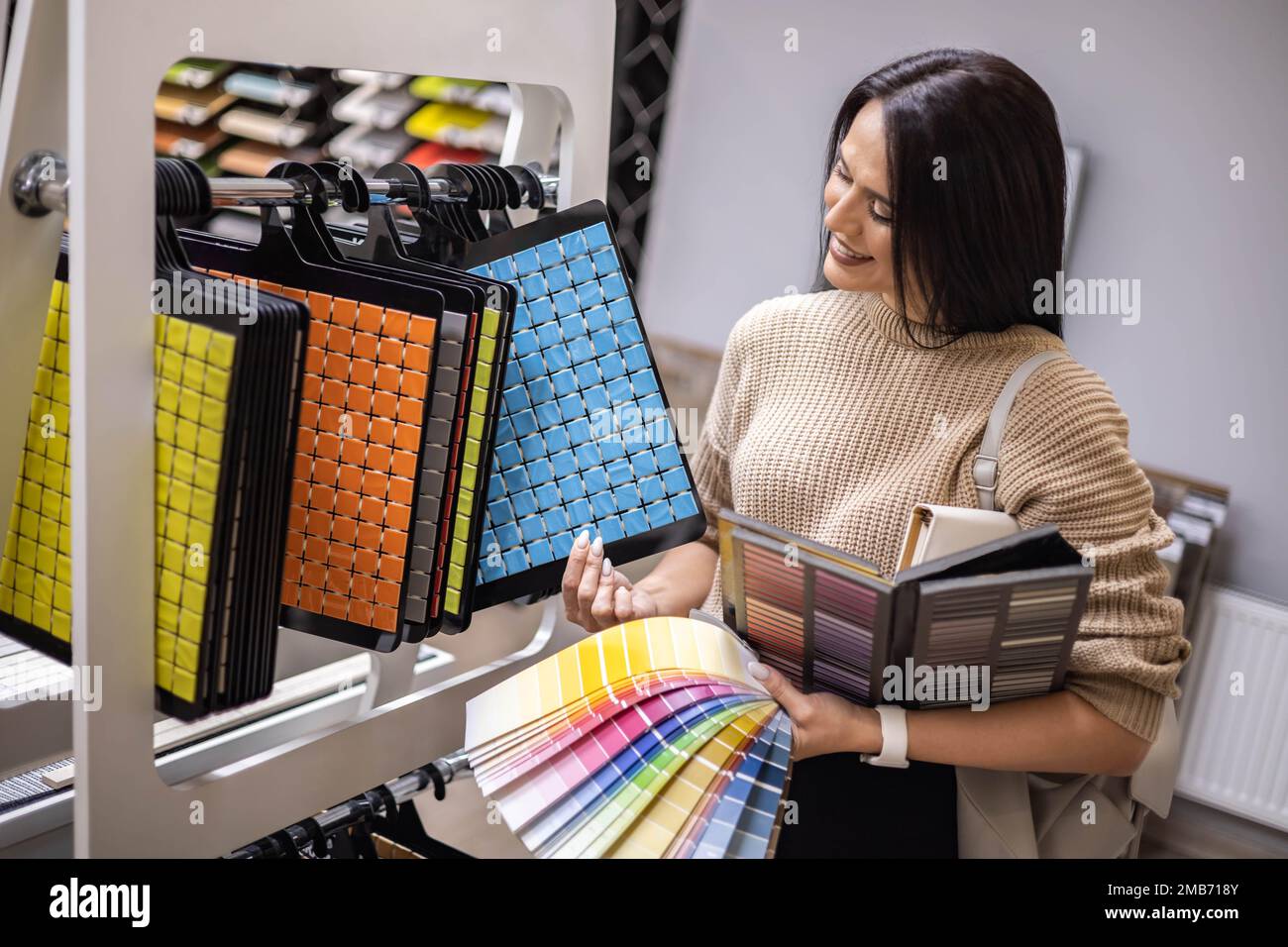 Professional interior designer female choosing ceramic tiles mosaic ...