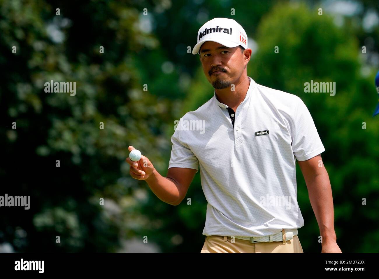 Satoshi Kodaira, of Japan, acknowledges the audience after putting on ...