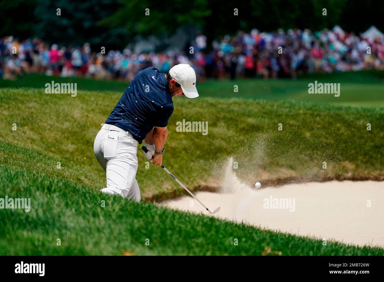 Rory McIlroy, of Northern Ireland, shoots out of the bunker on the ...