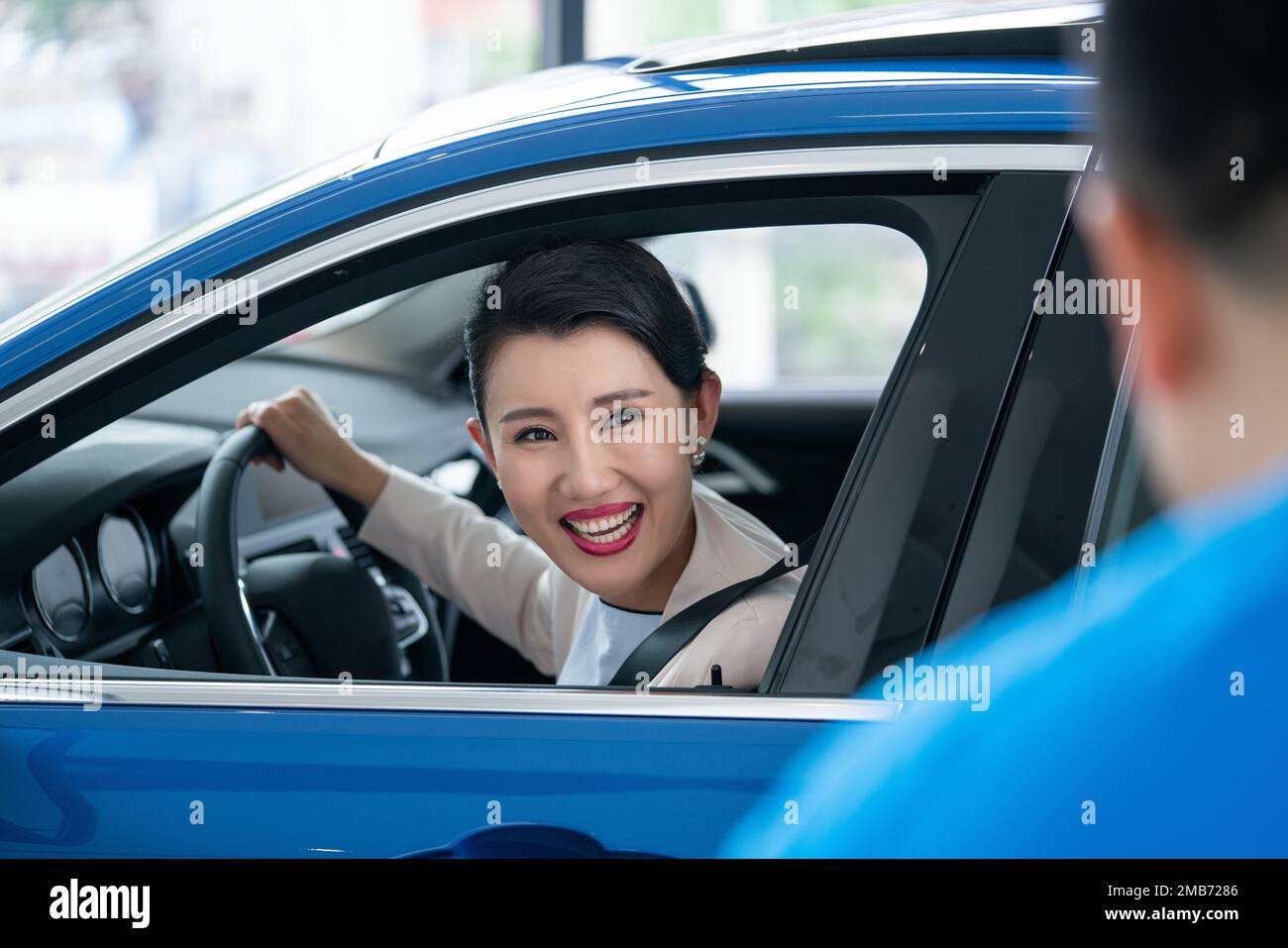 A young business woman driving Stock Photo - Alamy