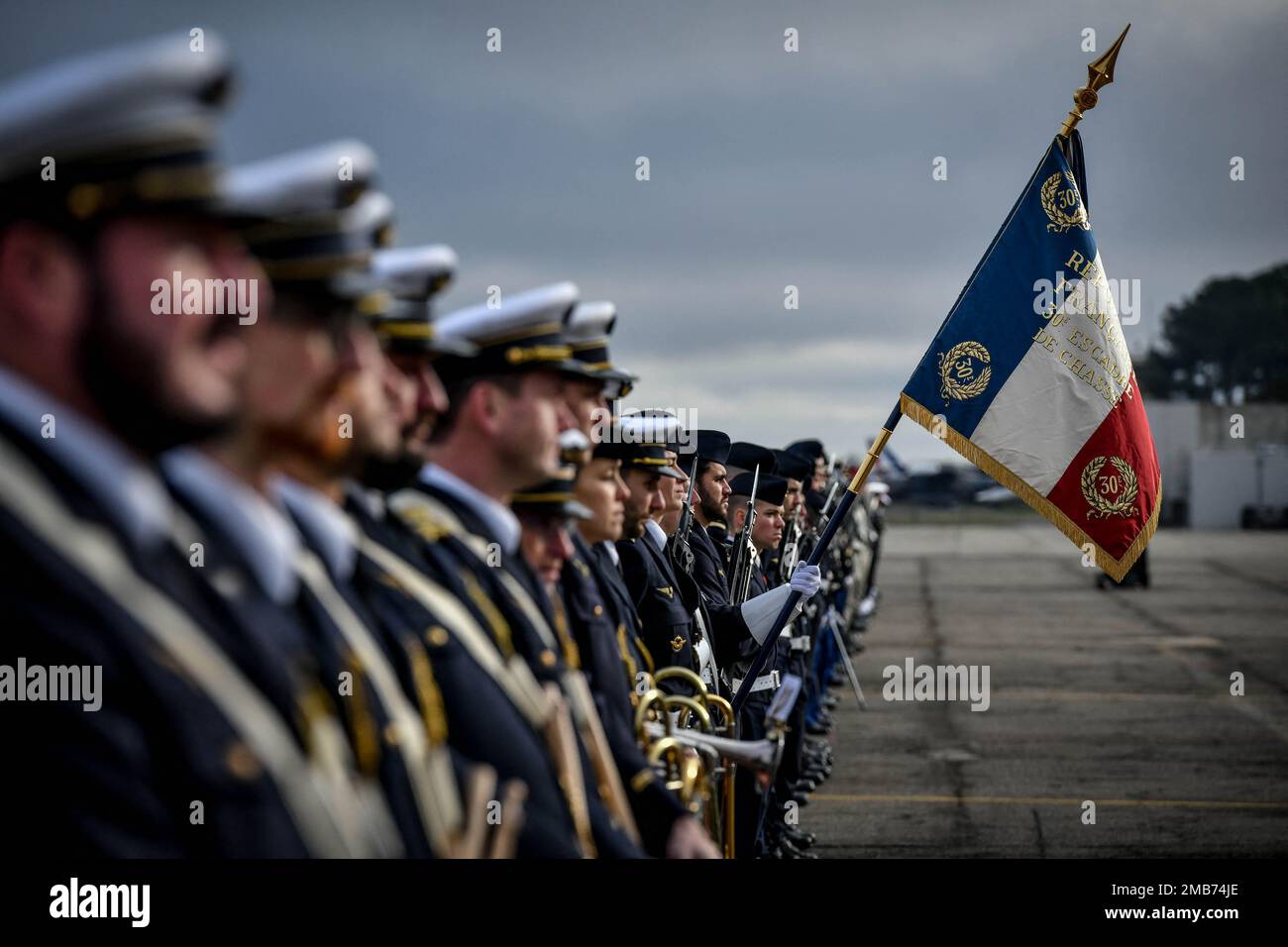 Militaries wait for a troop review by French president Emmanuel Macron ...