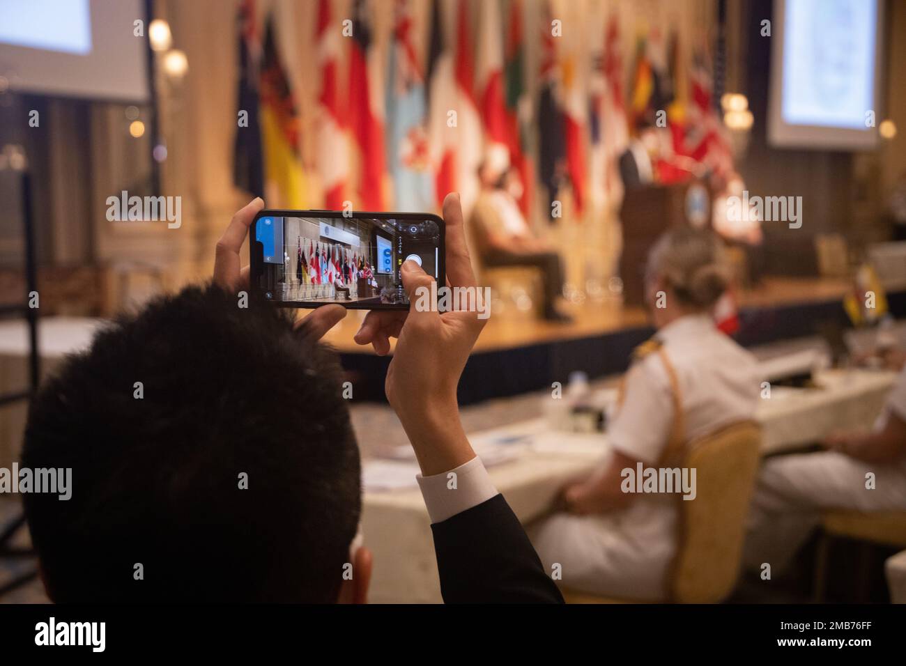 A Ceremony Attendee Takes A Photo Of The Opening Ceremony For The