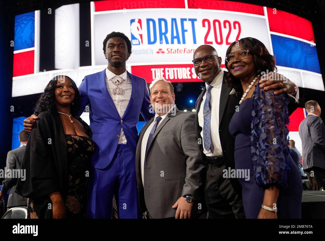 Mark Williams, second from left, poses for photos with family and ...