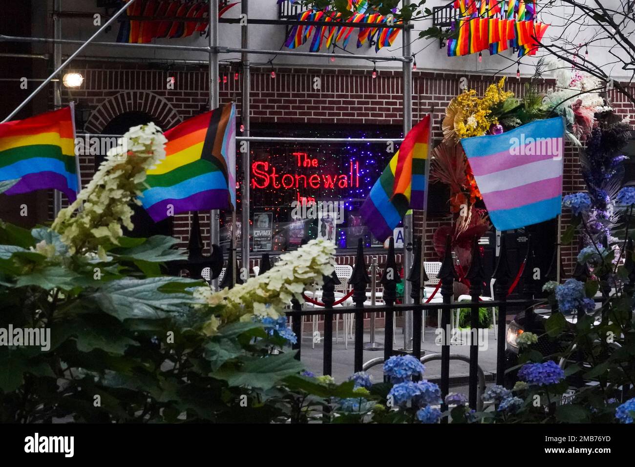 Flags affirming LGBTQ identity dress the fencing surrounding the ...