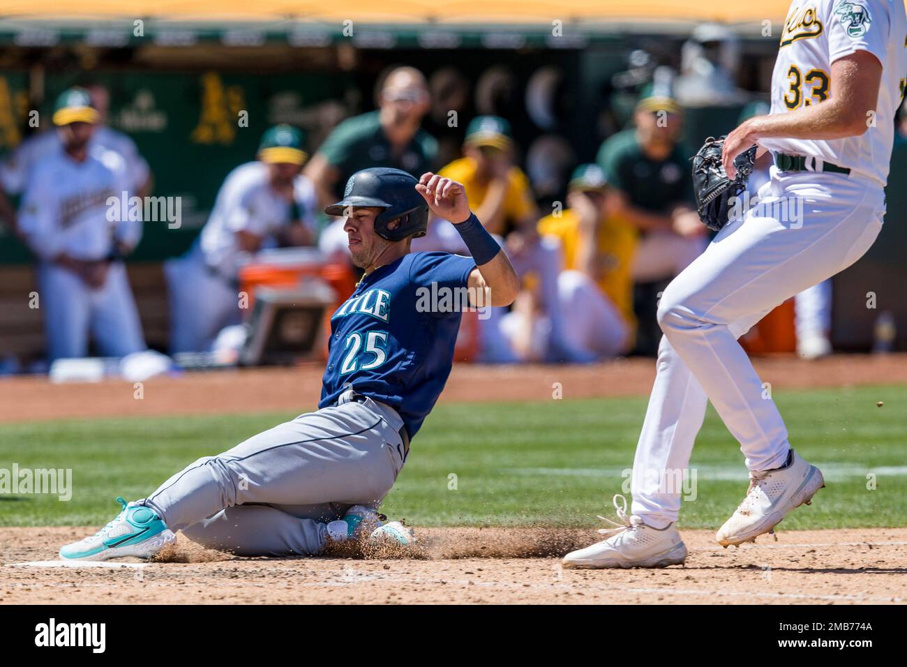 Seattle Mariners' Dylan Moore (25) scores on a wild pitch by Oakland ...