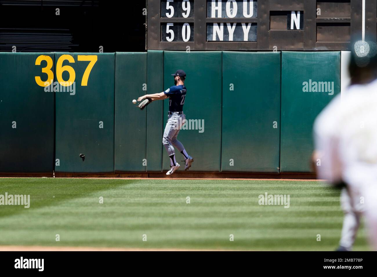 Seattle Mariners left fielder Jesse Winker struggles for possession of ...