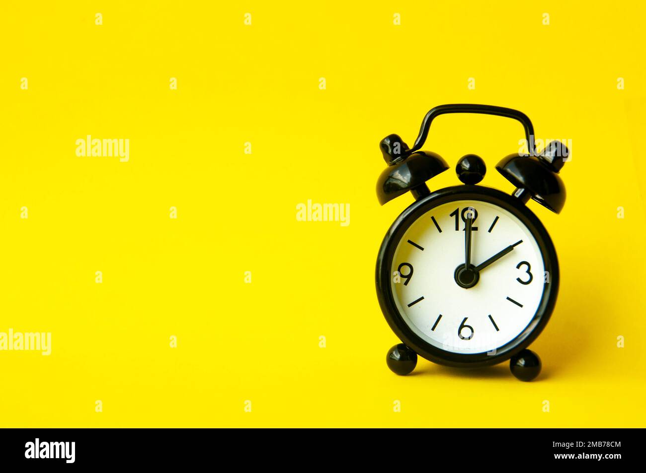 Alarm clock pointing at 2 am or pm with customizable space for text or ...
