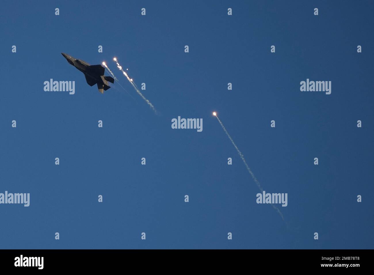 An Israeli air force F-35 war plane releases flares into the air during ...