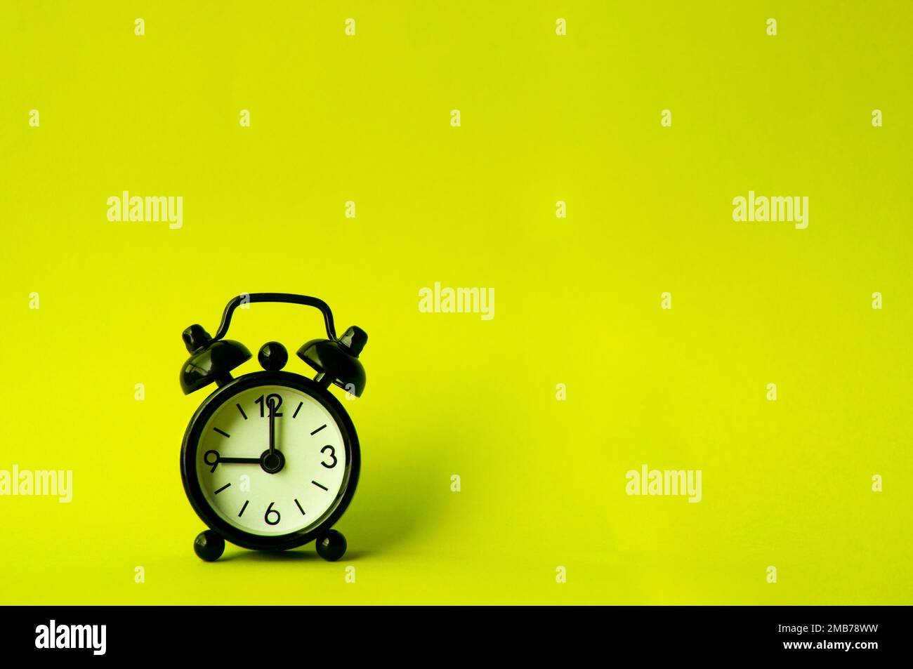 Alarm clock pointing at 9 am or pm with customizable space for text or ...