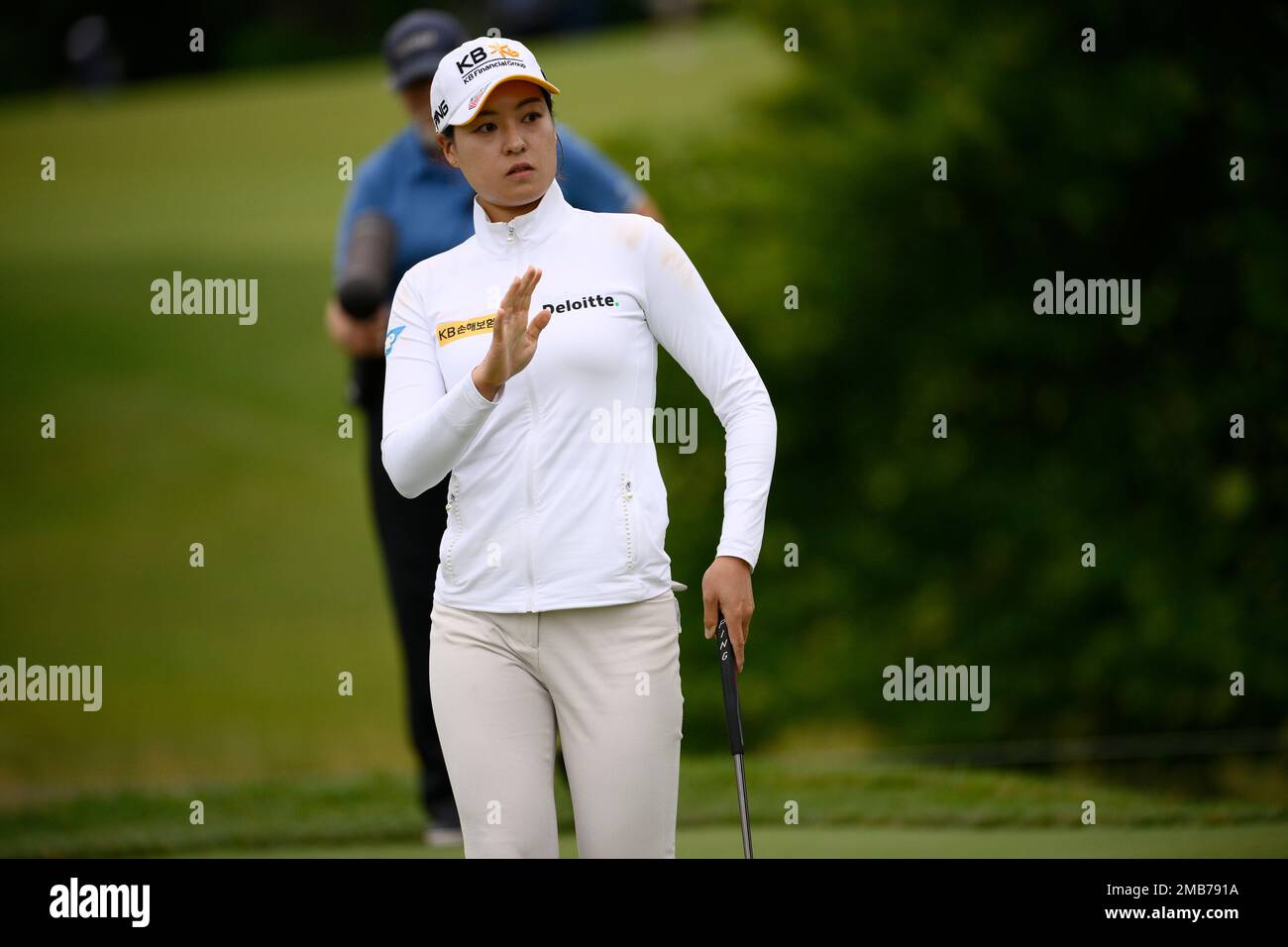 In Gee Chun, of South Korea, gestures after putting on the fourth green ...