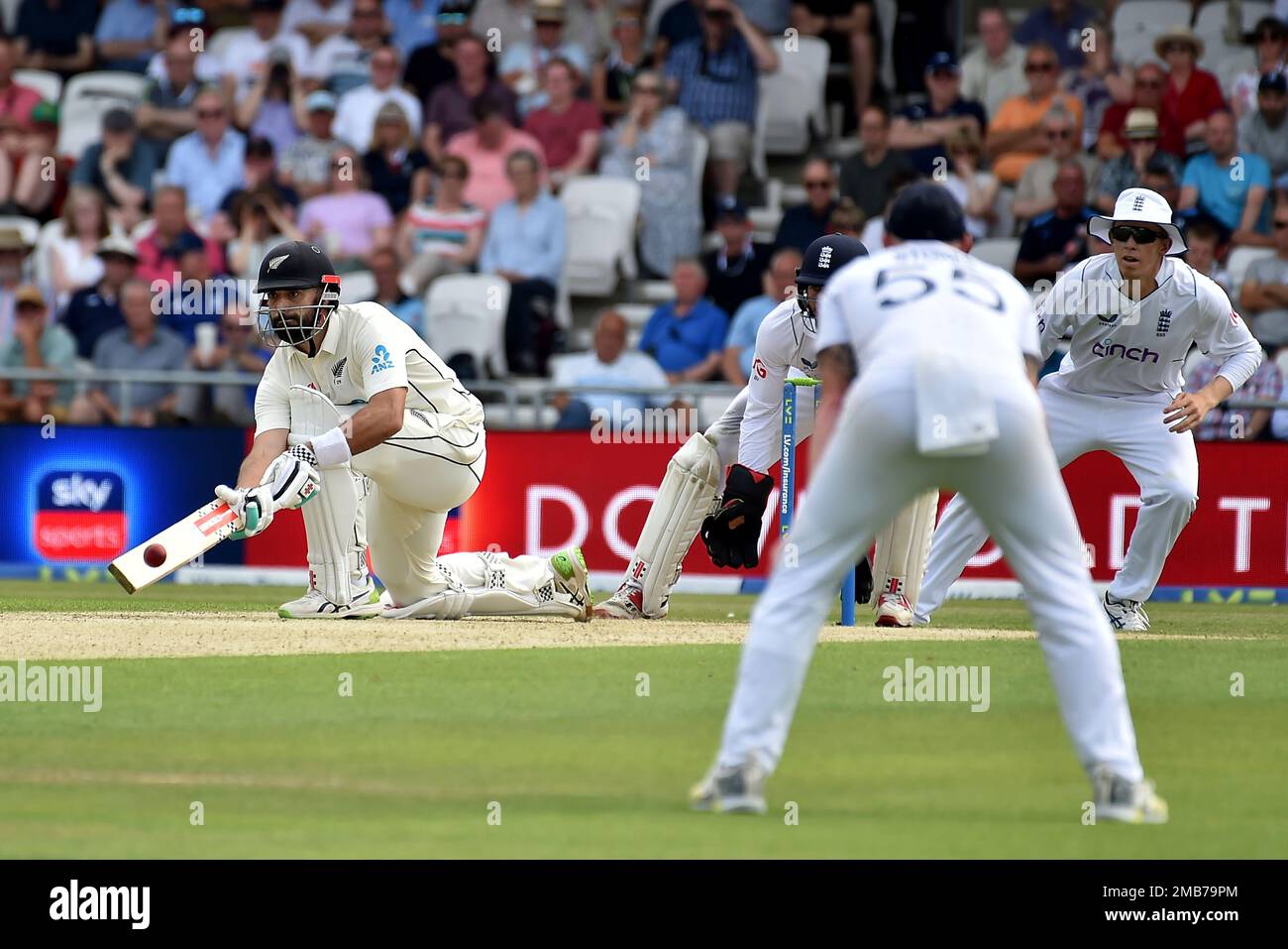 New Zealand's Daryl Mitchell, left, plays a shot during the first day ...