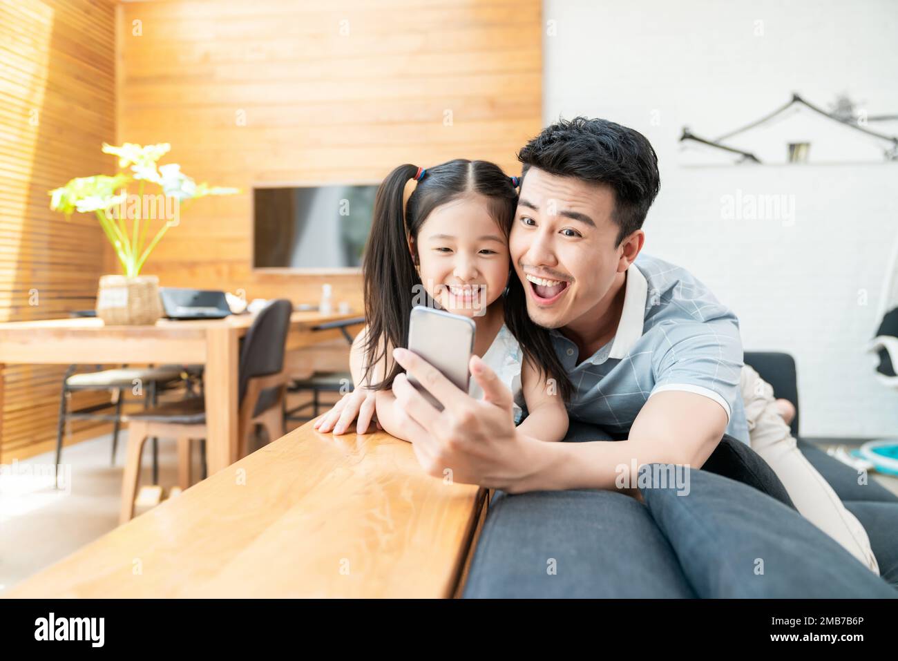 Happy father sitting on the sofa Stock Photo - Alamy