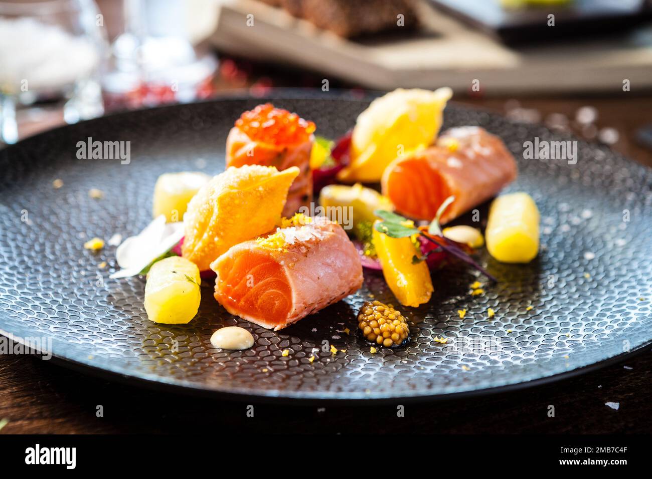 Salted Scottish salmon with trout roe. Marinated cucumber and onion ...