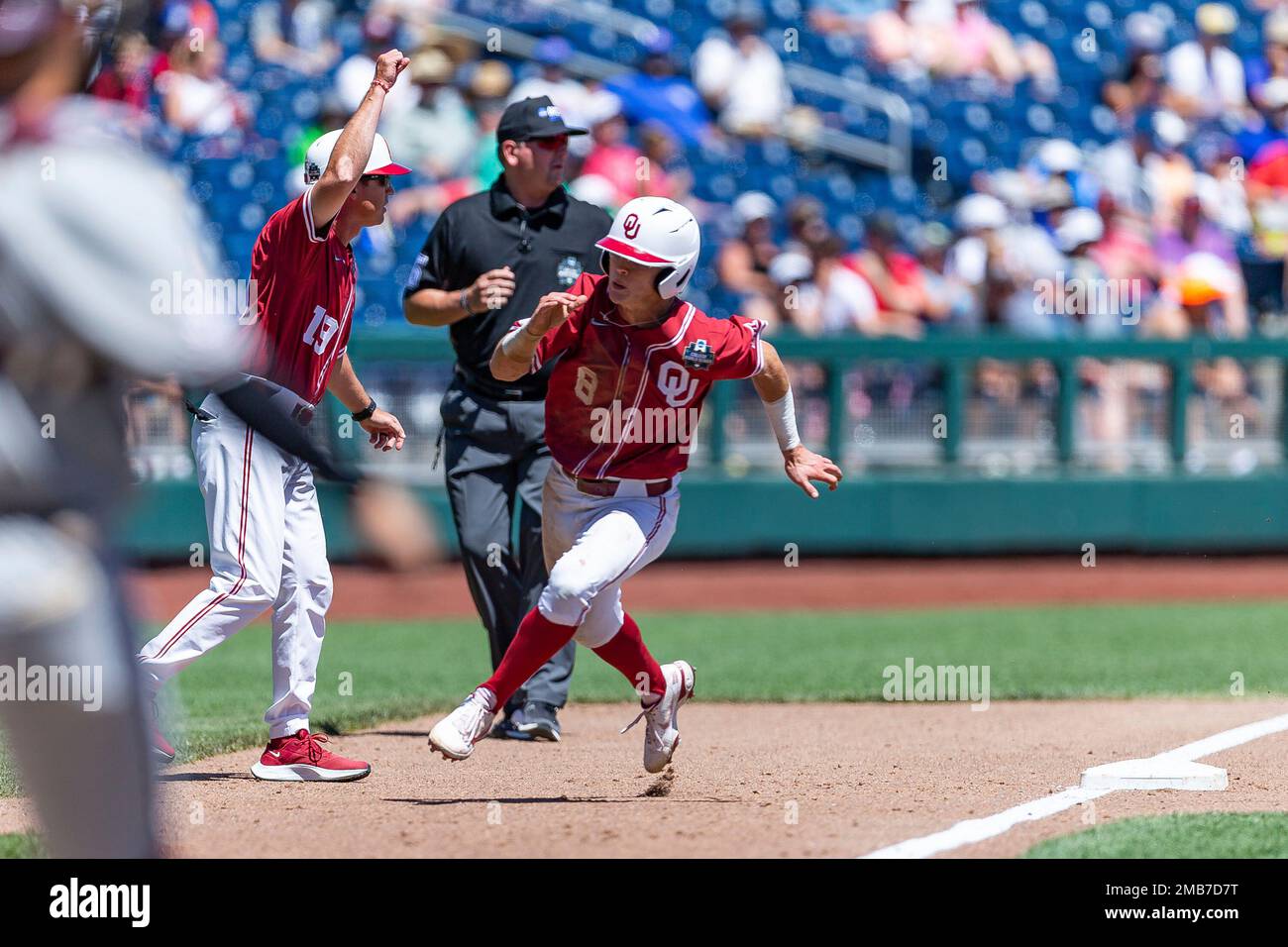 Oklahoma outfielder John Spikerman (8) rounds third base to score in ...