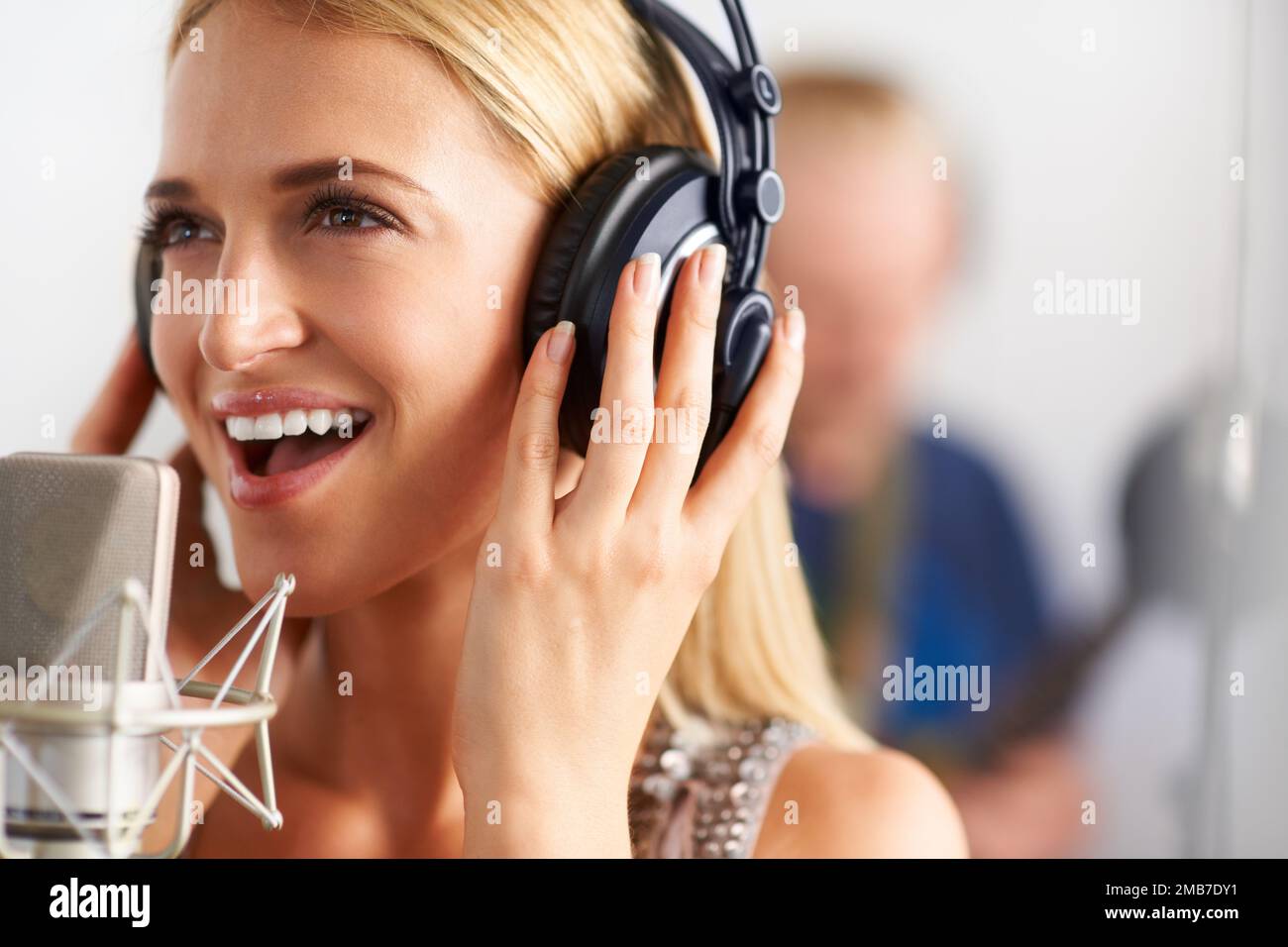 Beautiful blonde woman singing microphone hi-res stock photography and ...