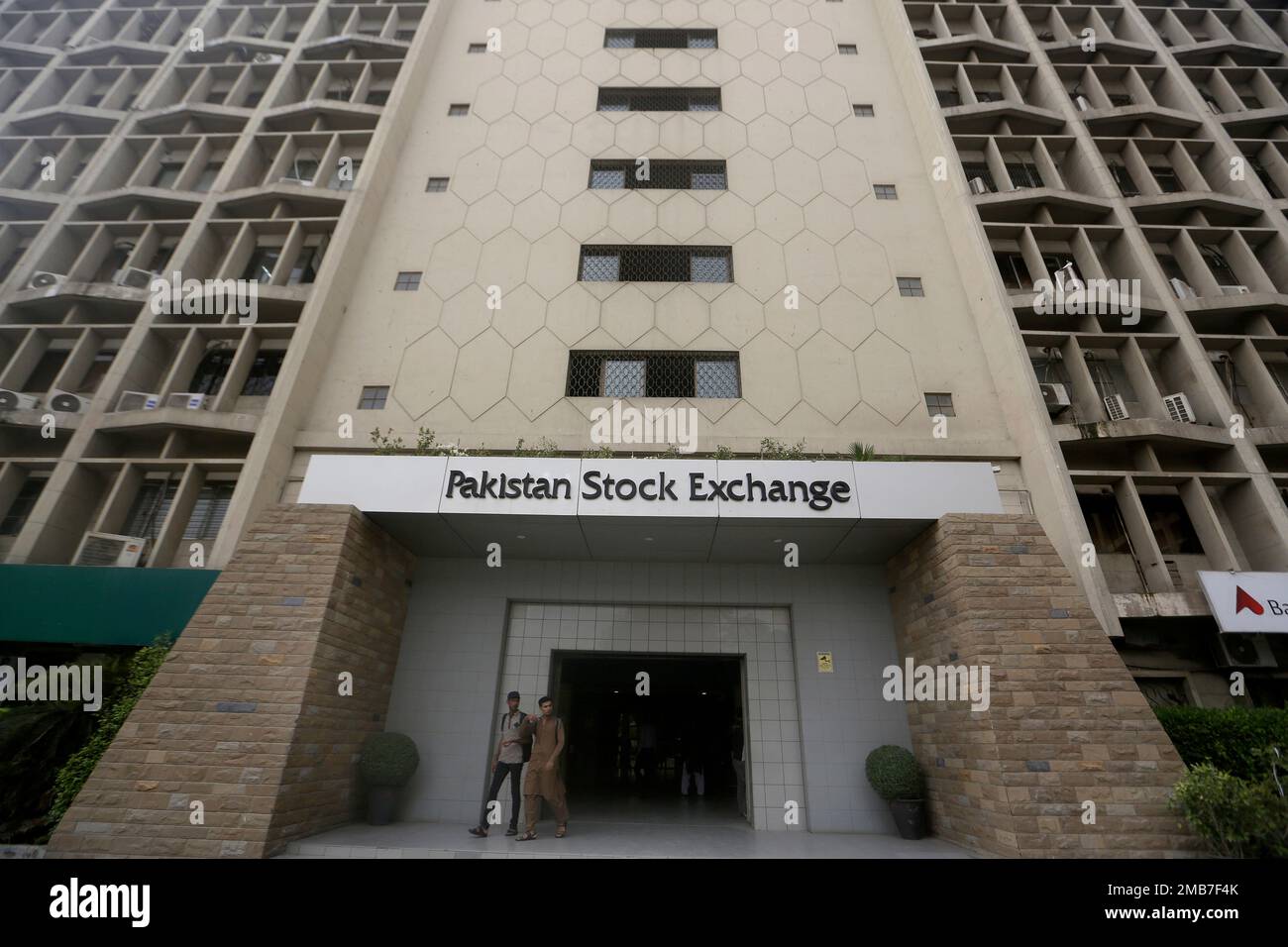 People come out from the Pakistan Stock Exchange, in Karachi, Pakistan ...