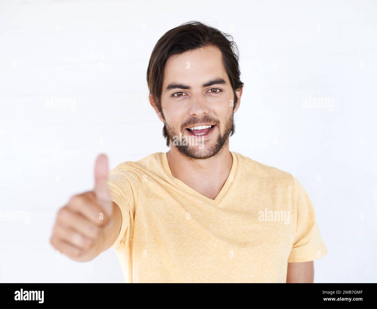 Thumbs up, portrait and man in studio, white background or isolated ...