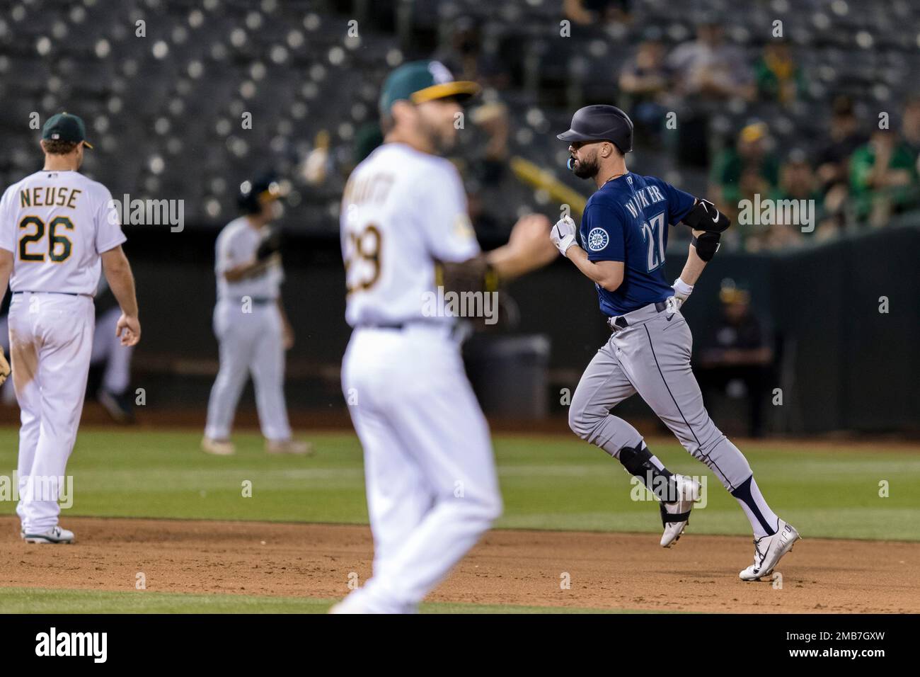 Seattle Mariners left fielder Jesse Winker, right, runs the bases after ...