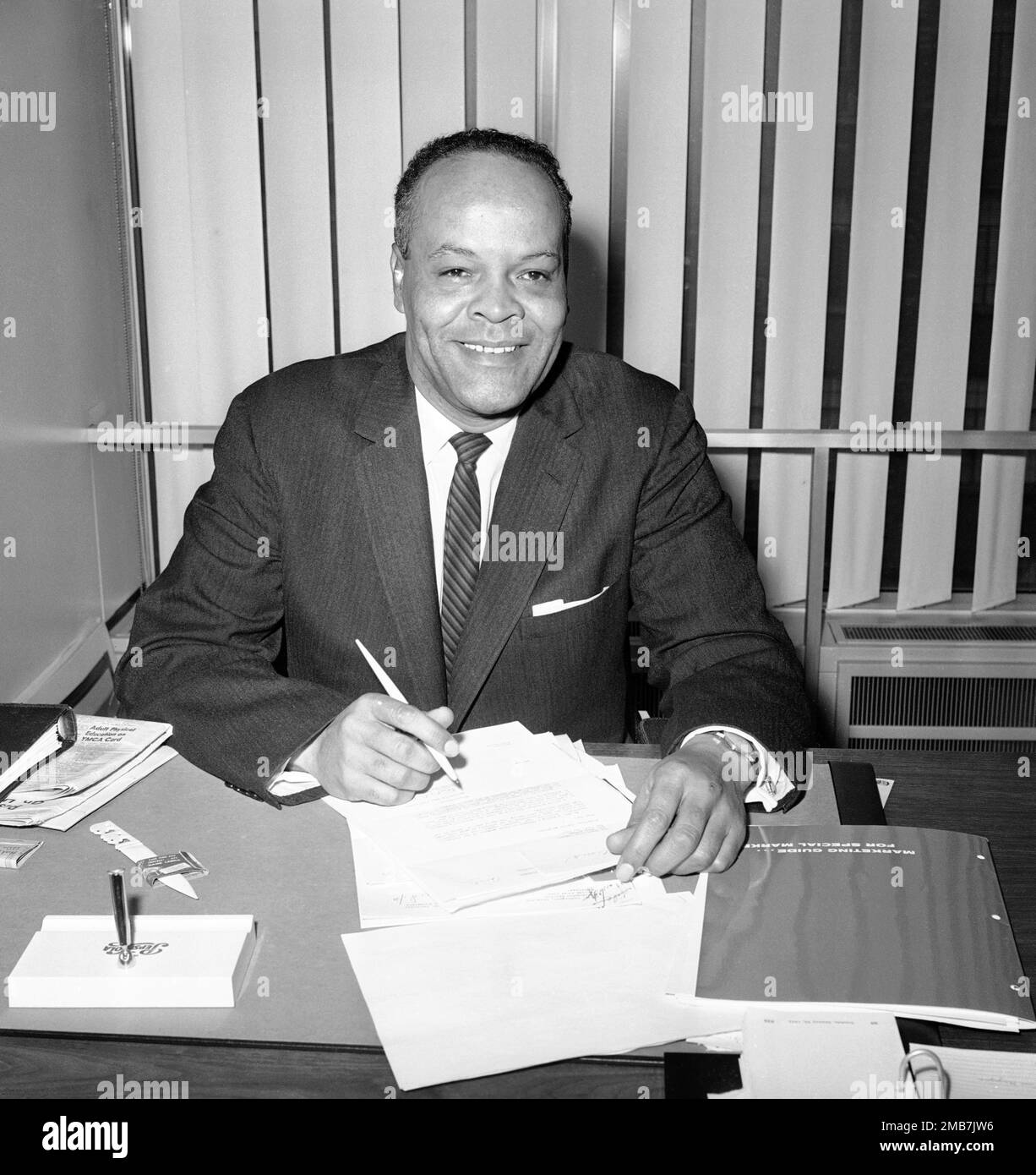 Harvey Russell, Vice President of Pepsi-Cola Co., is show in his office ...